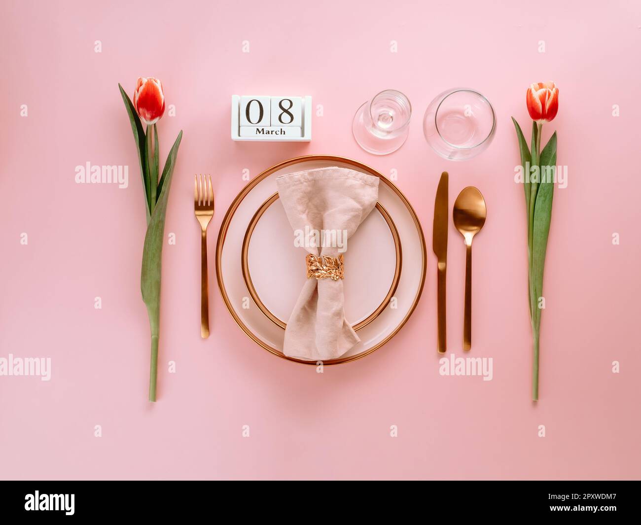 March 8 table setting. Pink plate with gold cutlery and, calendar with ...