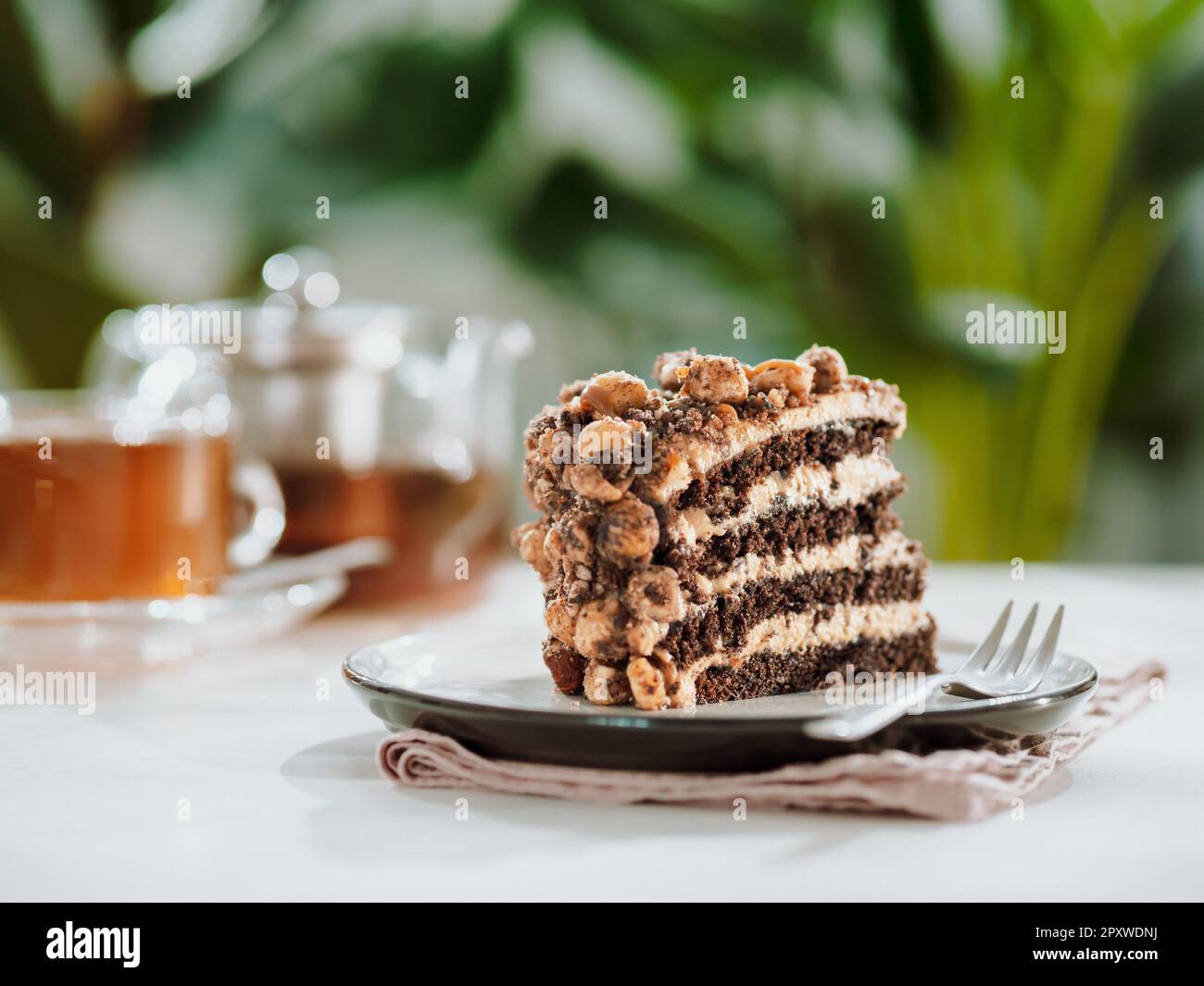 Perfect aesthetic layered cake with caramel and nuts on plate over gray ...