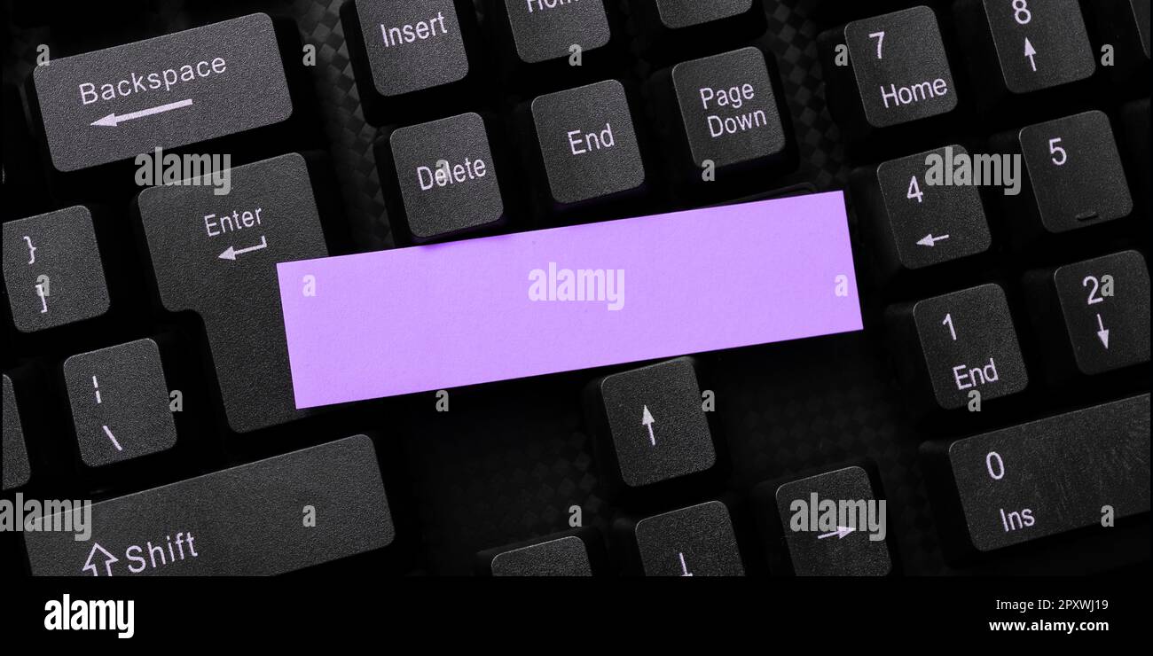 Sticker lying on black keyboard. Important message written over paper ...