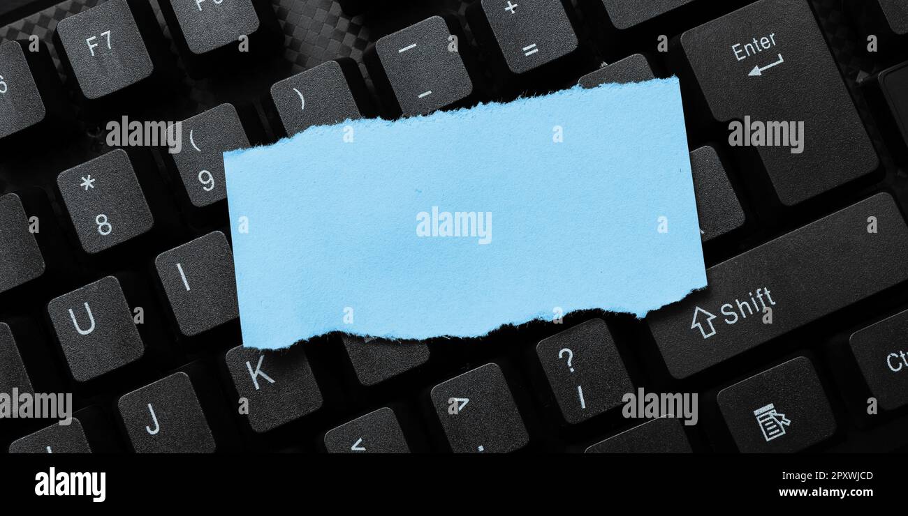 Sticker lying on black keyboard. Important message written over paper ...