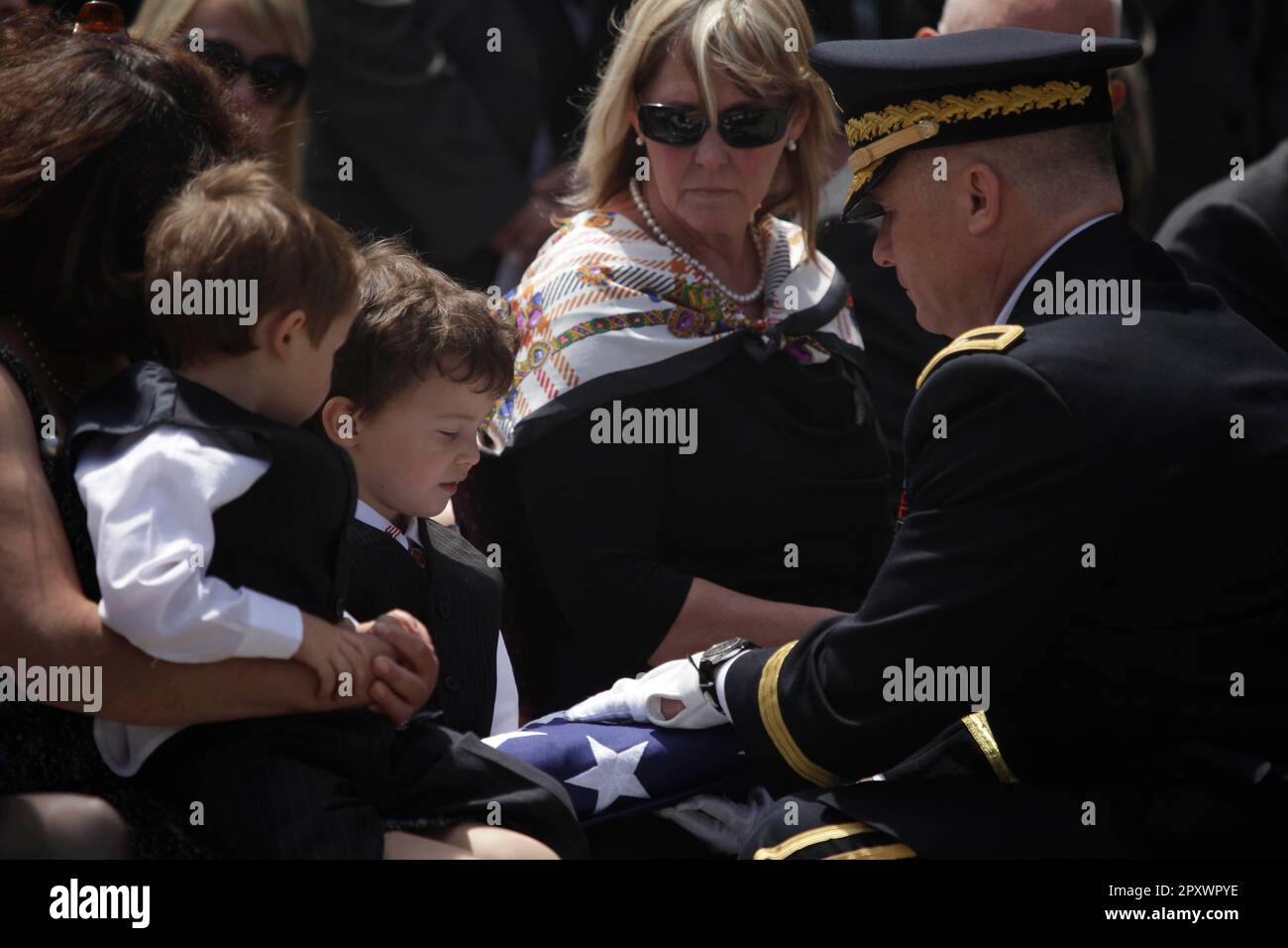 Brigadier General (P) Paul La Camera (right) presents a flag to Kellan ...
