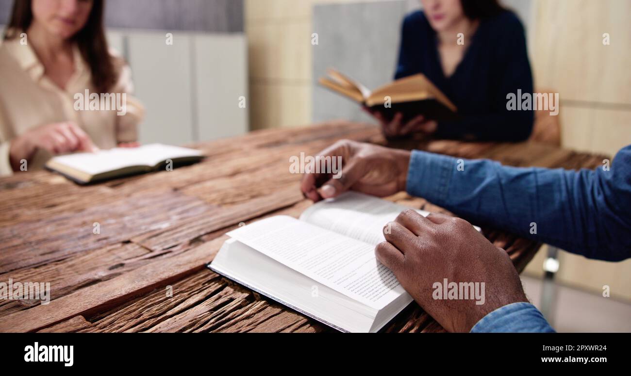 Young Multiethnic People Reading Bible Over Wooden Desk Stock Photo - Alamy