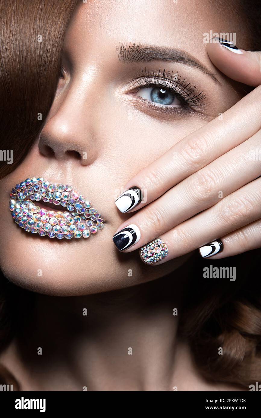 Beautiful girl with bright nails and lips of crystals, long eyelashes ...