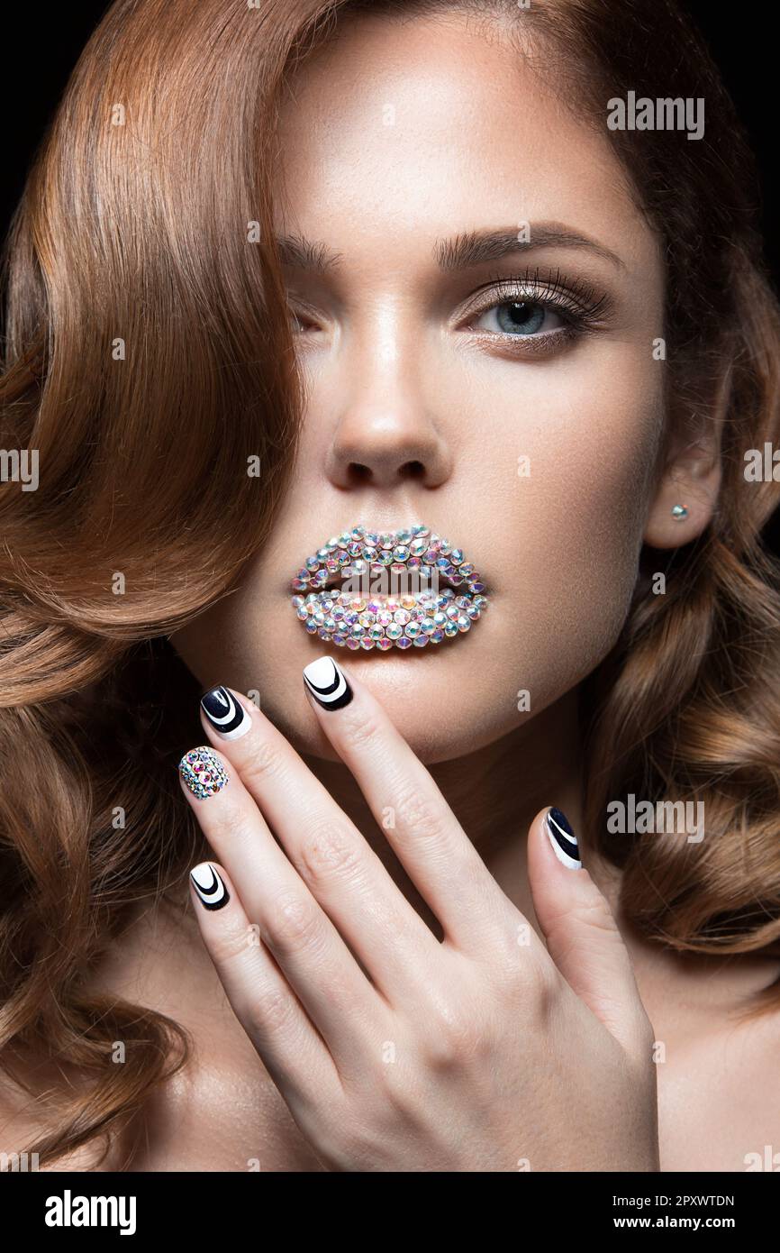 Beautiful girl with bright nails and lips of crystals, long eyelashes ...