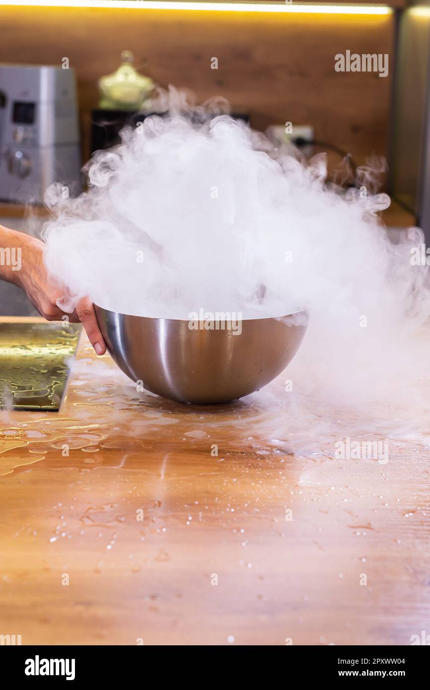 smoke vapor dry ice in bowl in the kitchen Stock Photo - Alamy