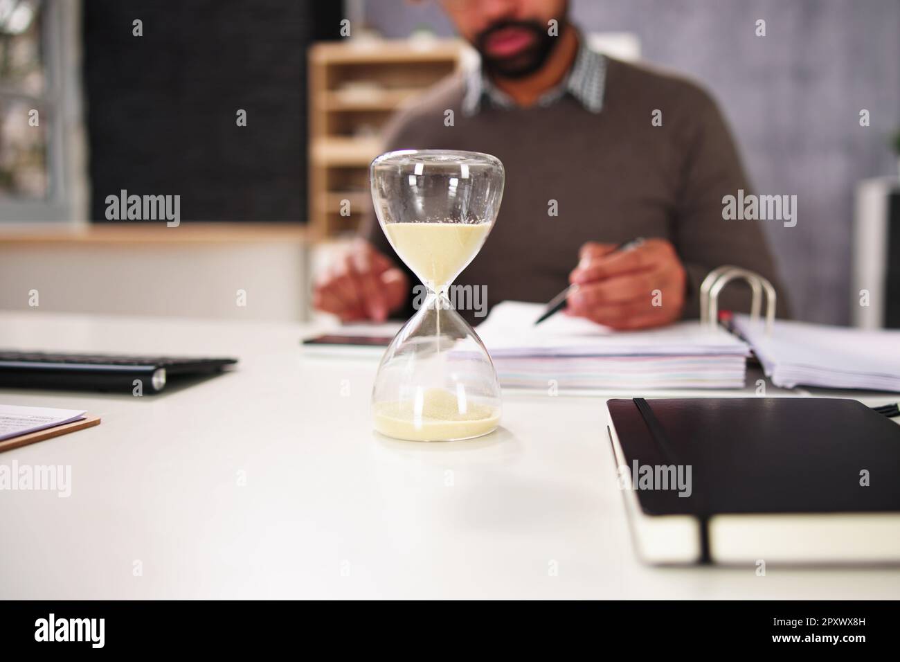 Late Invoice And Billing Deadline With Hourglass At Desk Stock Photo ...