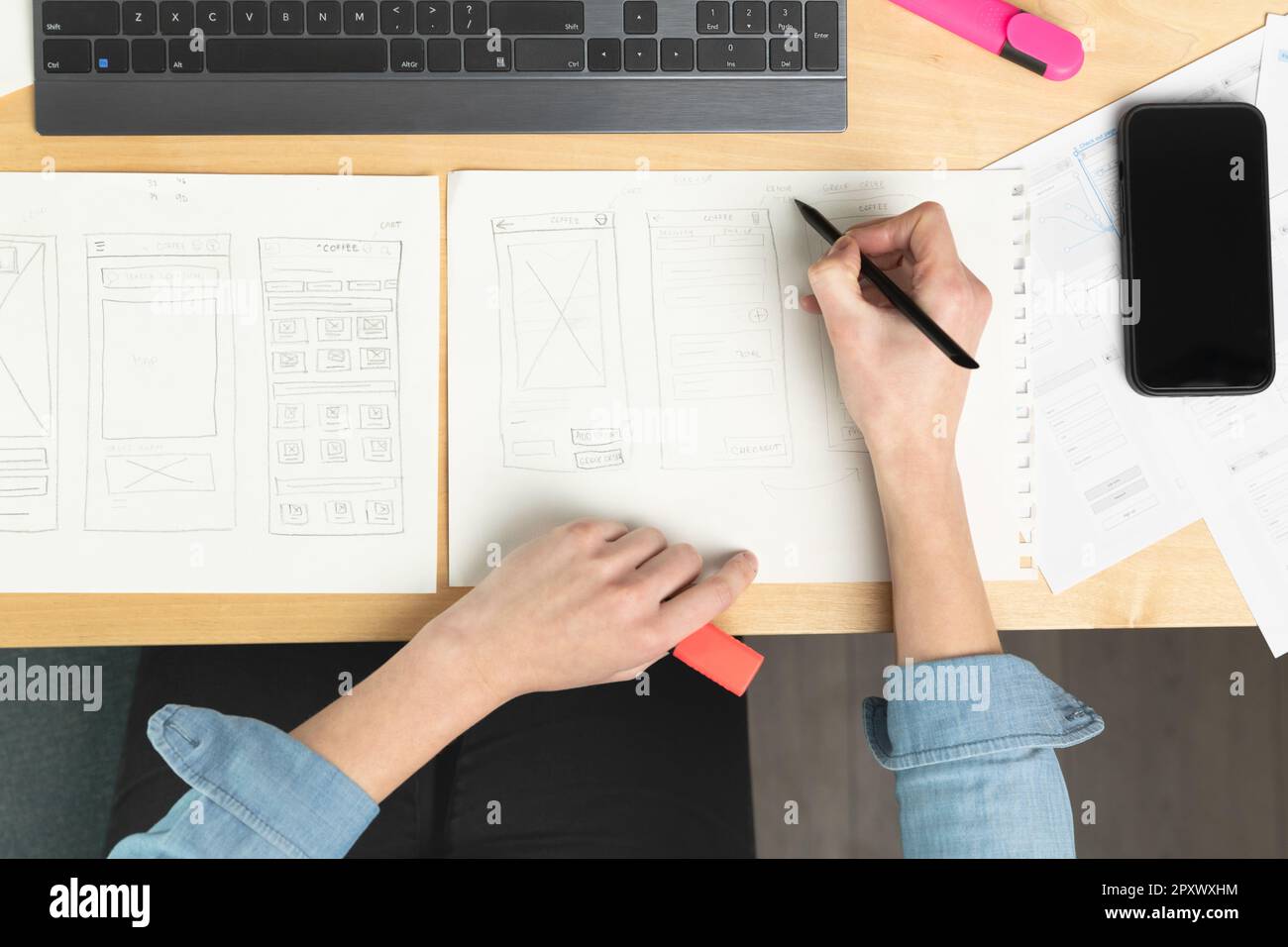 Sketch of wireframe for website. Women designer working on a mobile ...