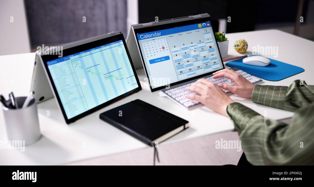 Employee Looking Calendar Schedule On Computer Screen Stock Photo - Alamy