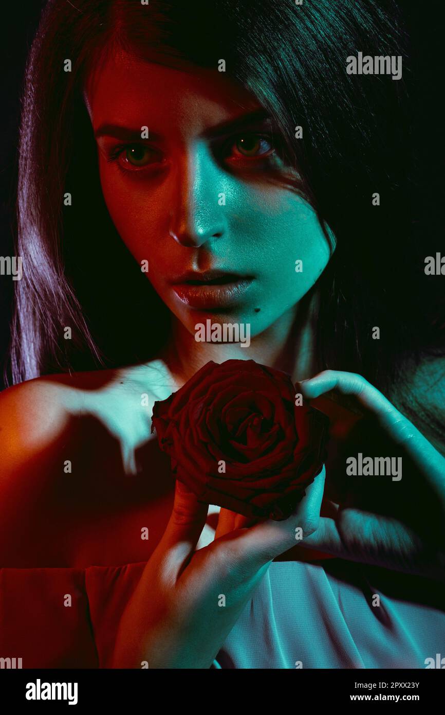 Beautiful girl with a rose in her hand. The beauty of the face ...