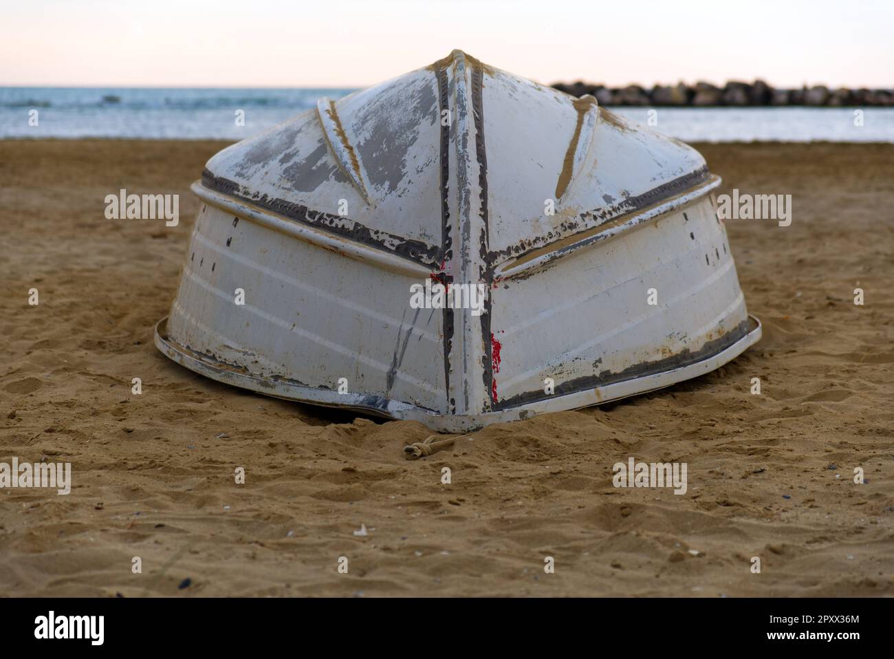 the keel of a small boat capsized on the beach Stock Photo - Alamy