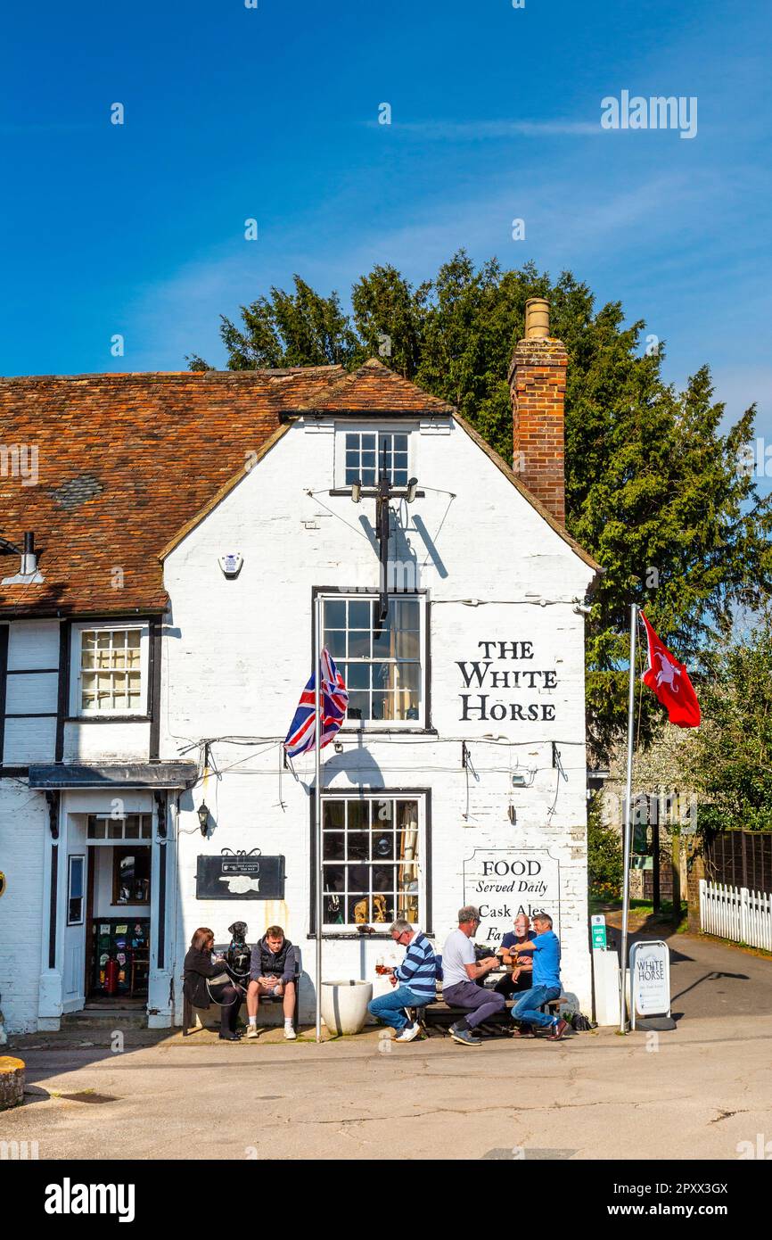 People enjoying a sunny day at the 14th century White Horse Inn pub ...