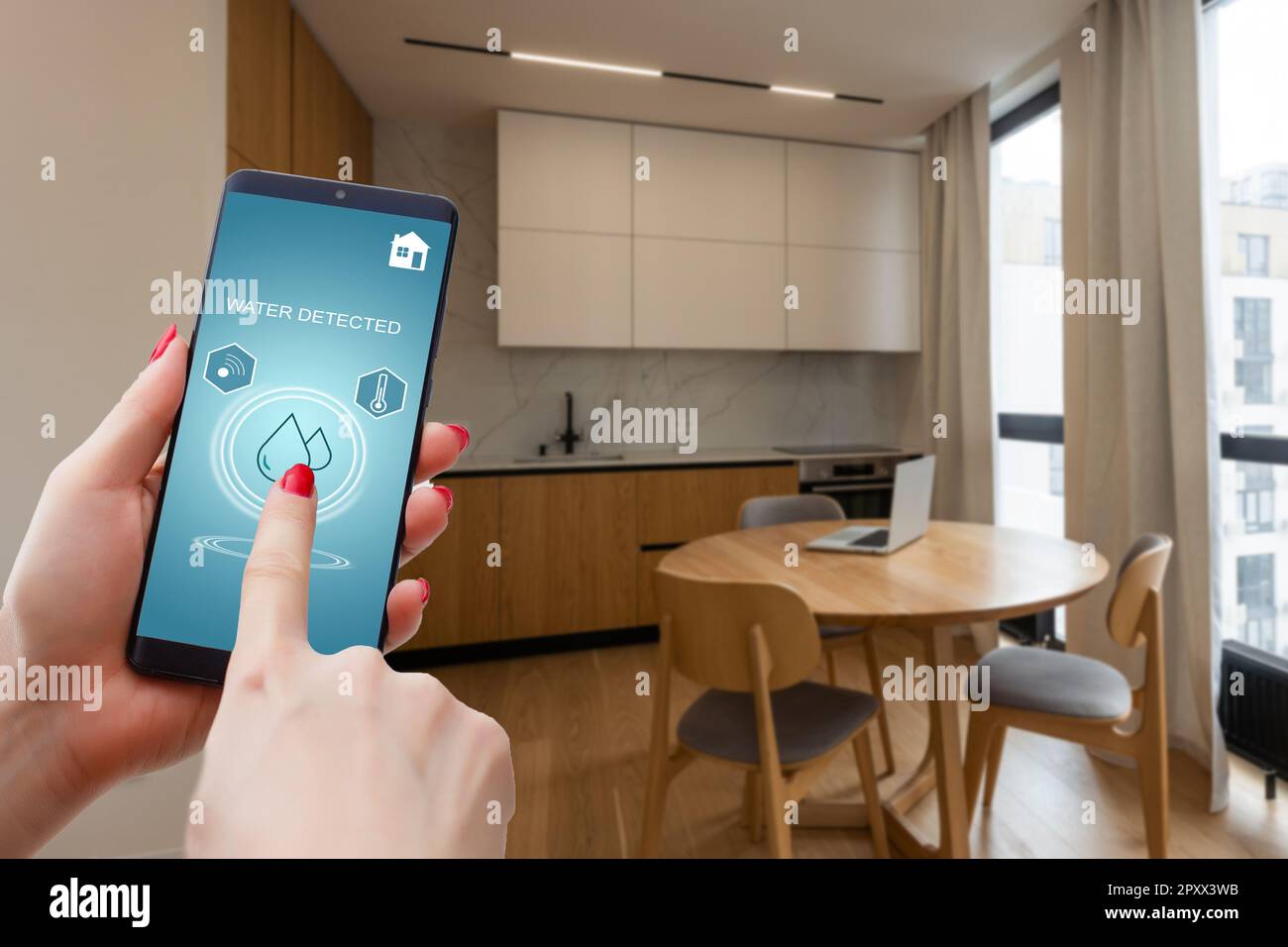 Hand holding smart phone with home control application with water ...