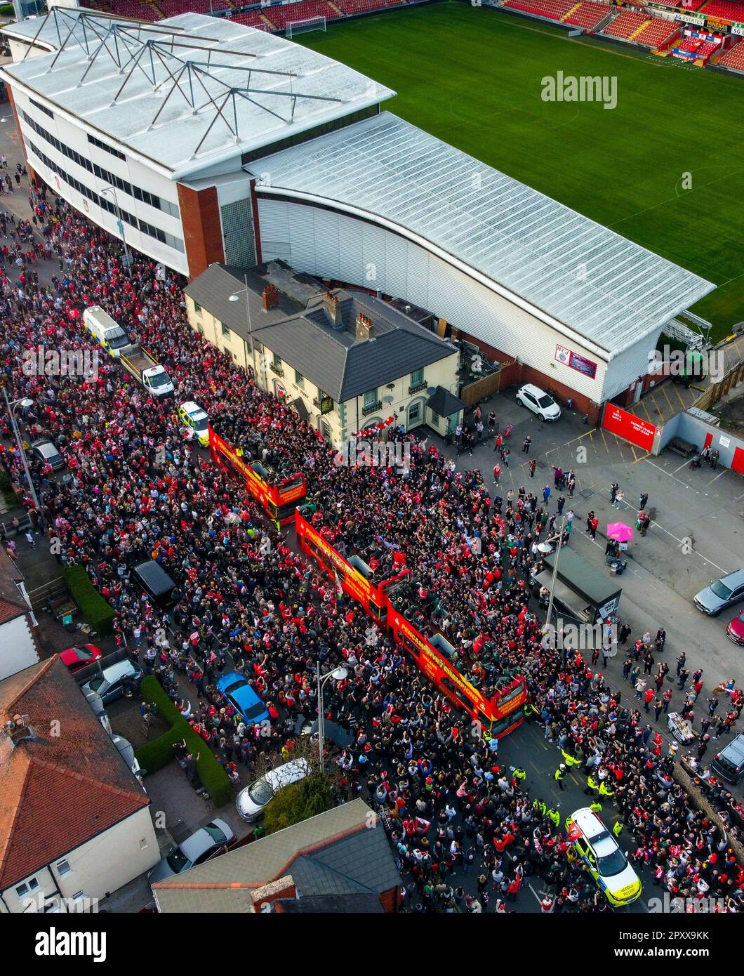 An aerial view of open-top busses carrying Wrexham players passing the ...