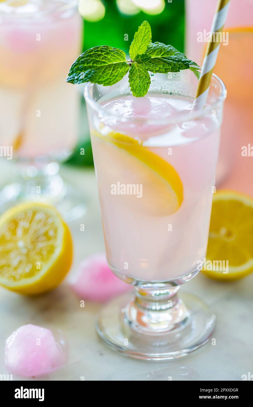Cold and frosty lemonade with pink lemonade ice cubes, ready for drinking Stock Photo - Alamy