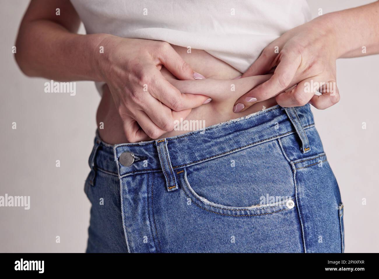 Stomach Fat Liposuction And Diet. Stomach Skin Pinch Stock Photo - Alamy