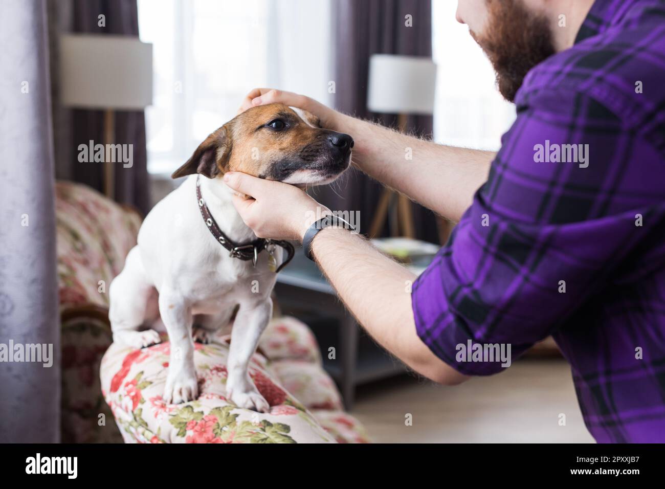 Close Up portrait handsome young hipster man loves his good friend dog ...
