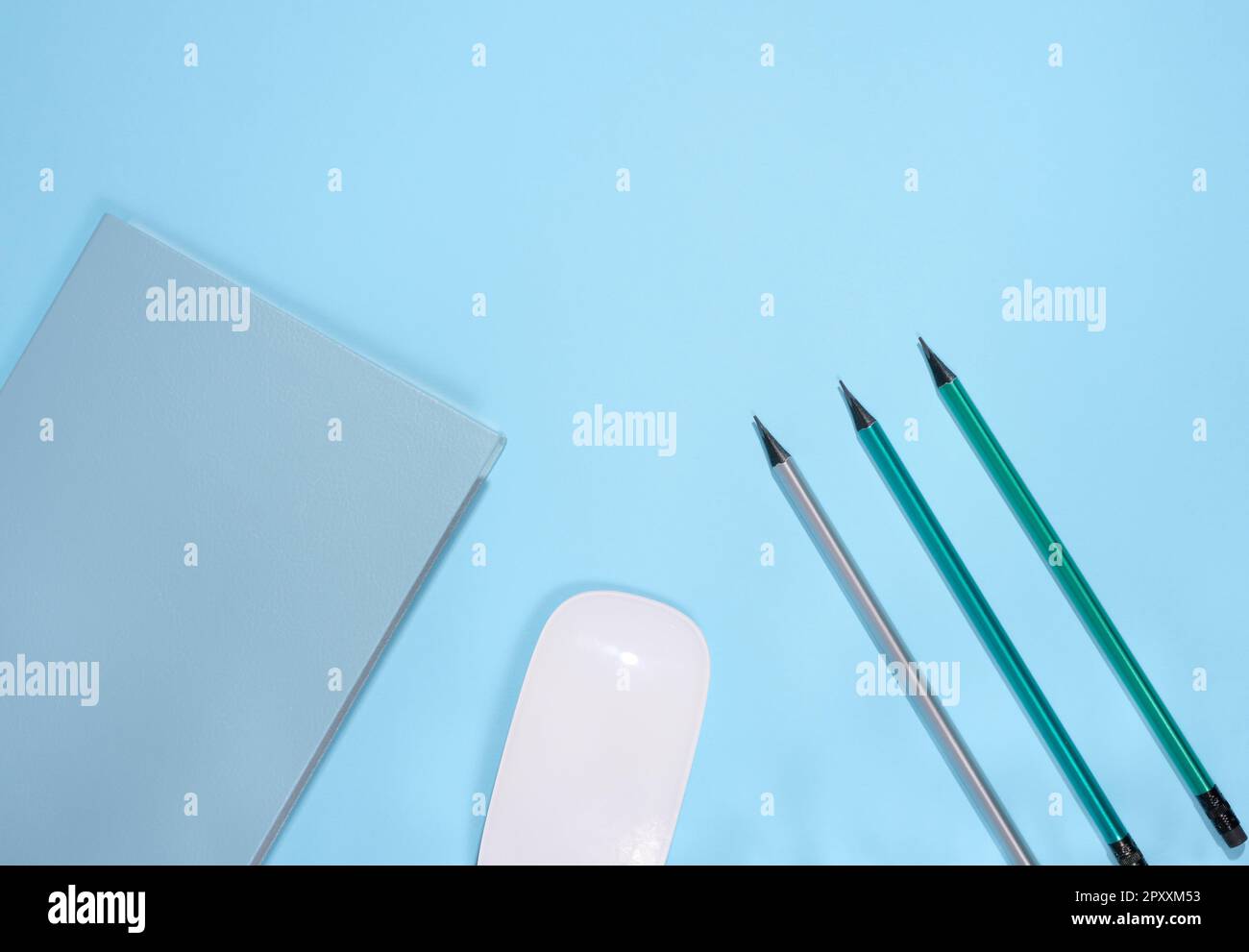 Blue notepad and wooden pencil on a blue background, top view Stock ...