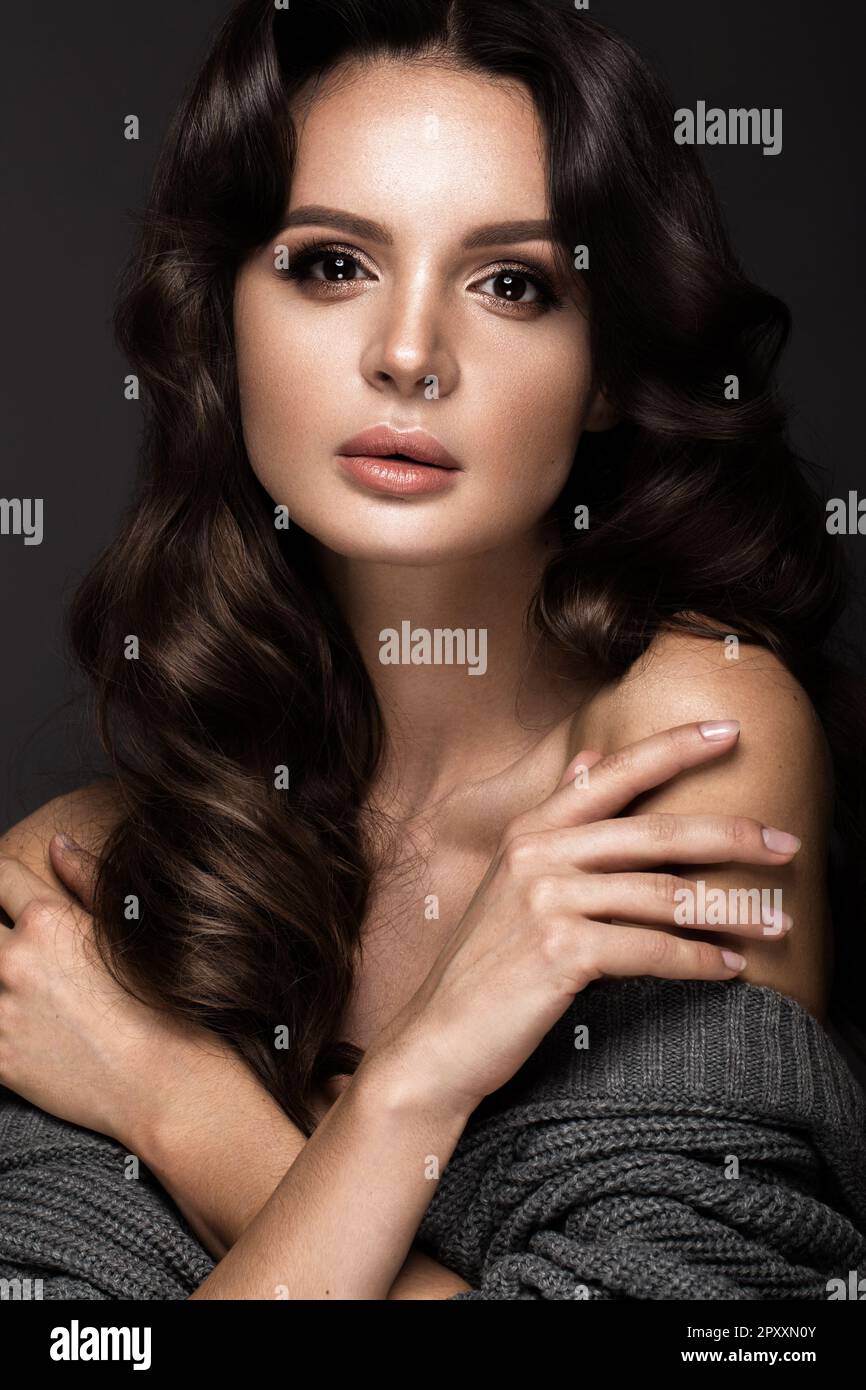 Beautiful woman with healthy skin and hair curls, posing in studio ...