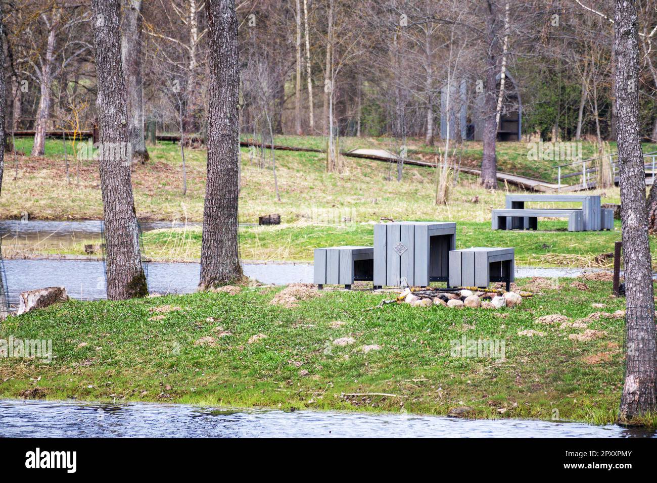 A forest with trees and a lake with many trees and rest areas with ...