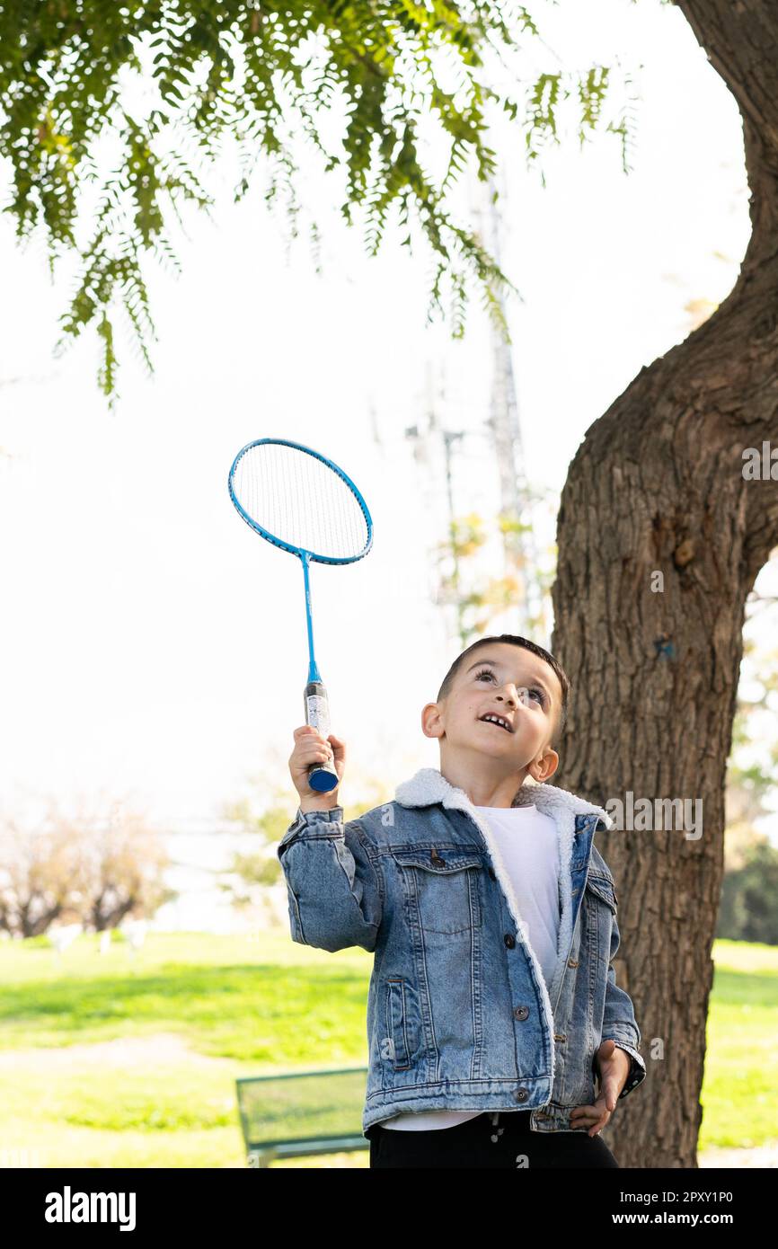 Active Child Playing Badminton in Sunny City Park, Having Fun with ...