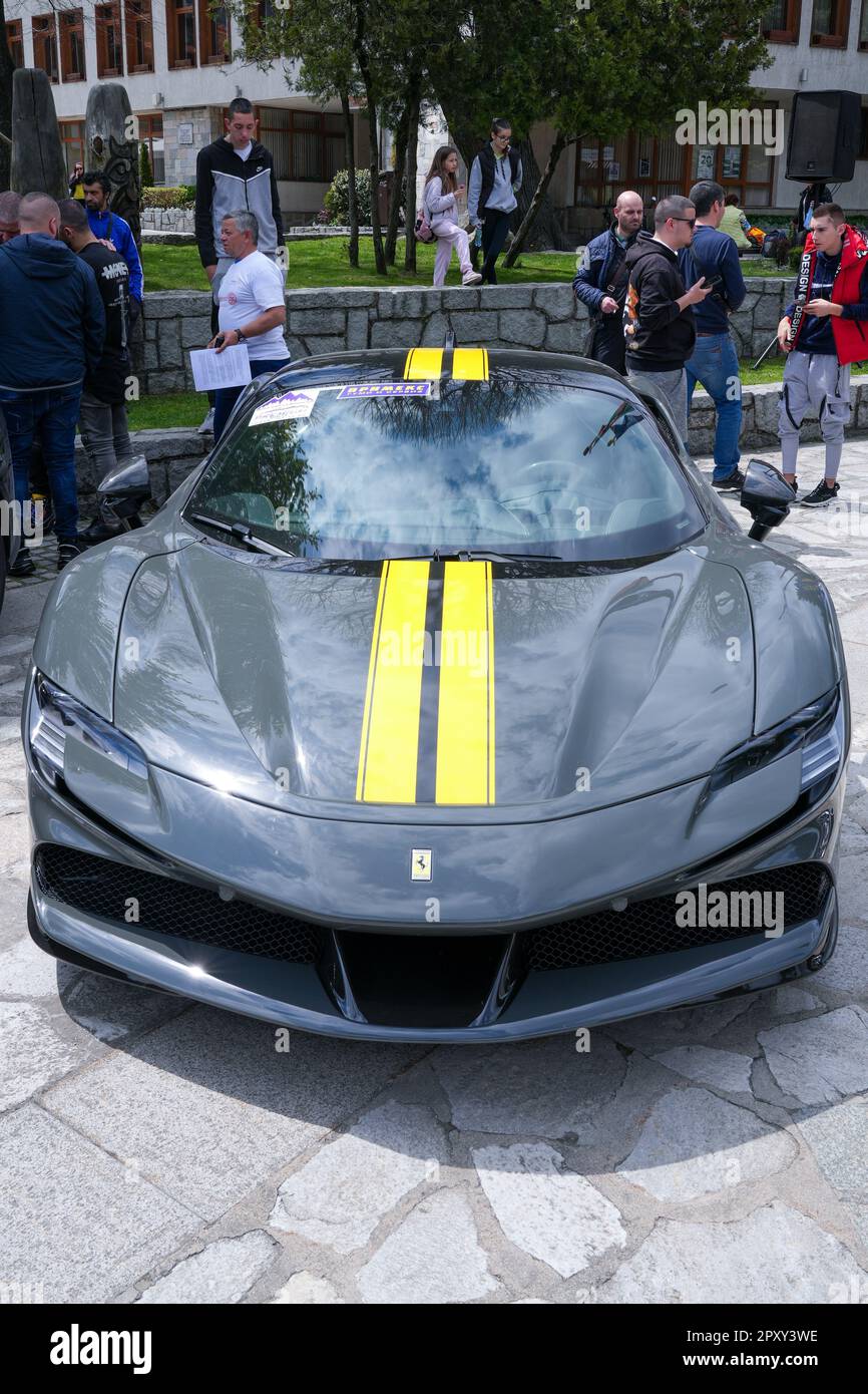 A grey Ferrari car is parked in a busy public area Stock Photo - Alamy