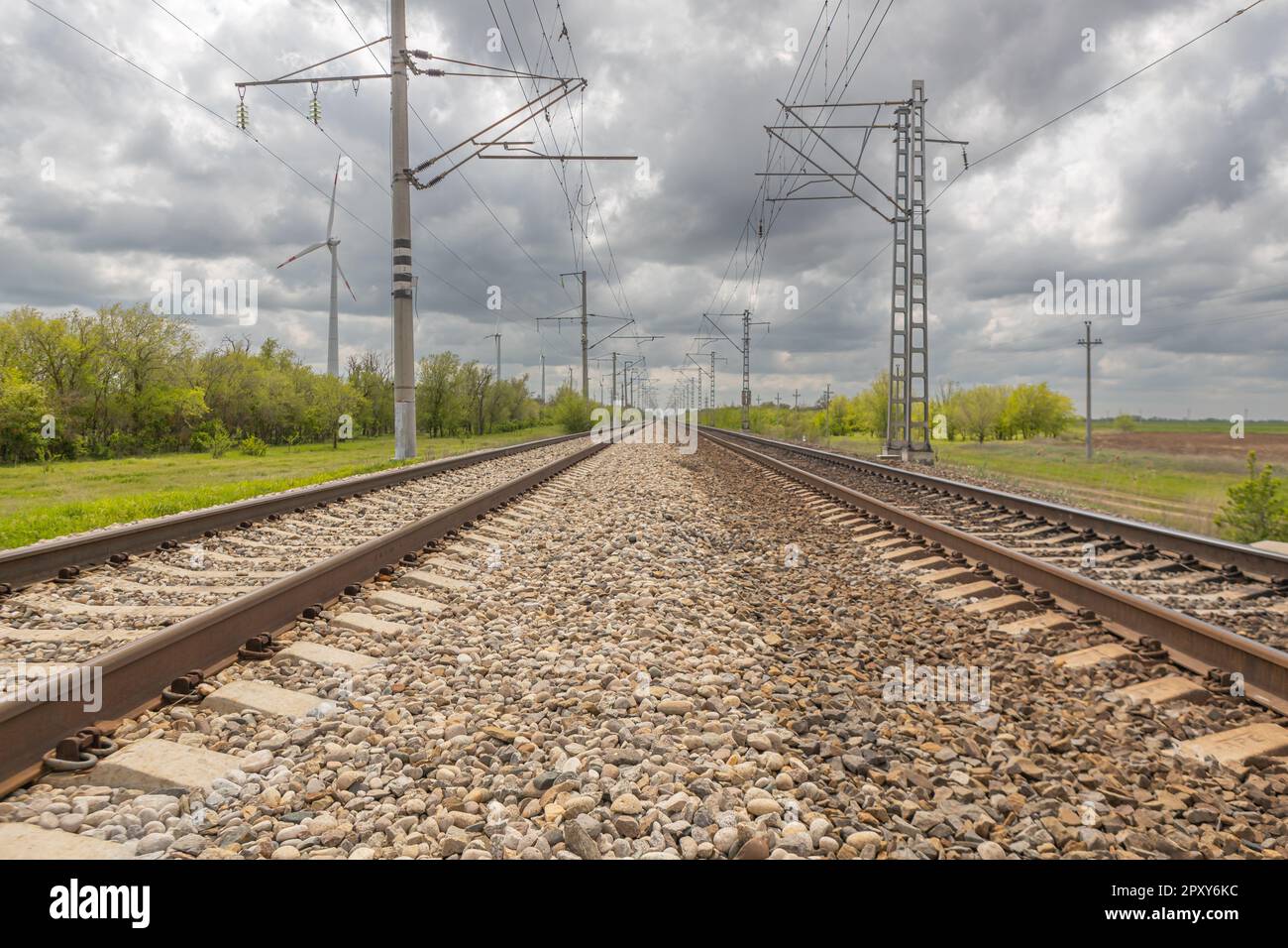 in spring, the railway tracks go into the distance, blue sky with white ...