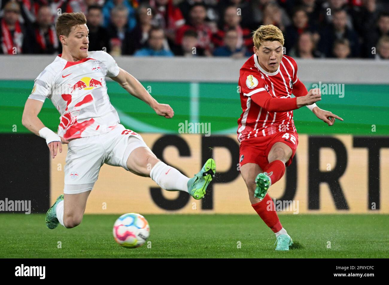 Freiburg's Ritsu Doan, right and Leipzig's Marcel Halstenberg, left ...
