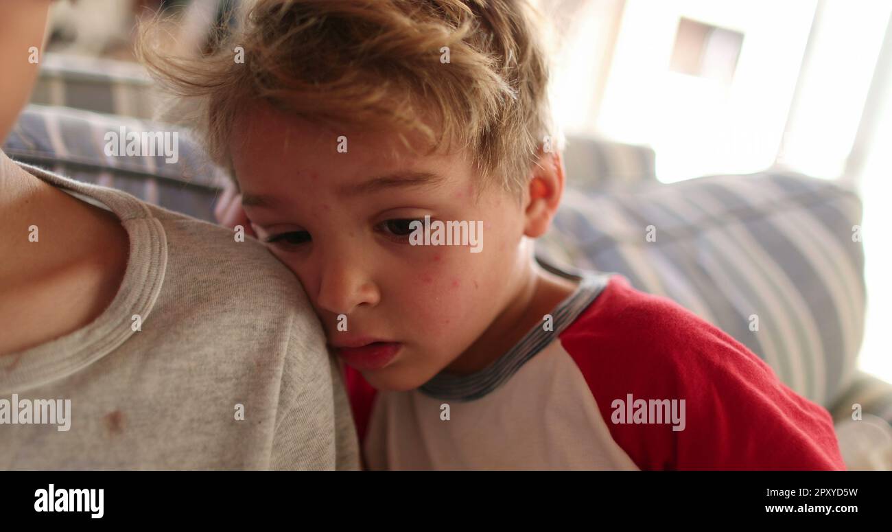 Child in the morning waking up overlooking brother shoulder, real life ...