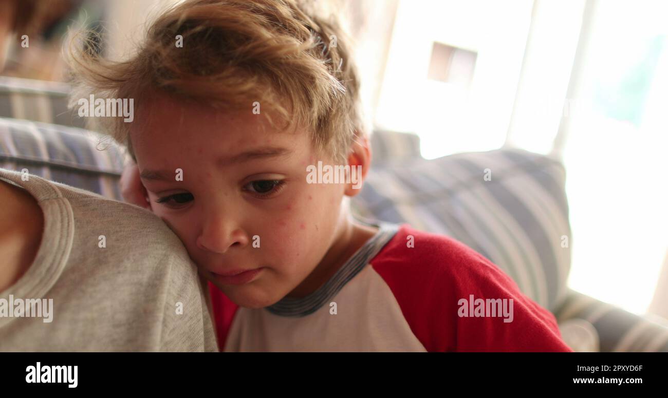 Child in the morning waking up overlooking brother shoulder, real life ...