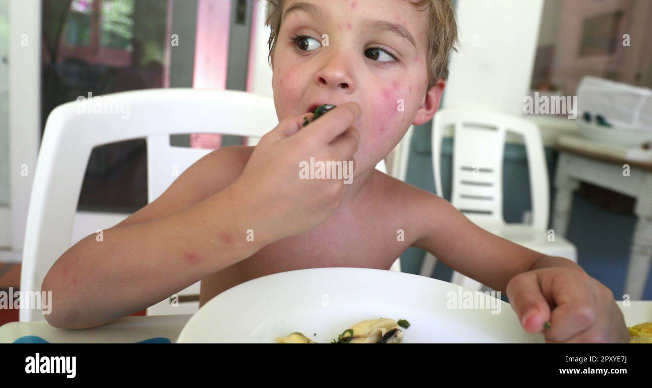 Child eating seafood mussels. Toddler boy eats moules food Stock Photo ...