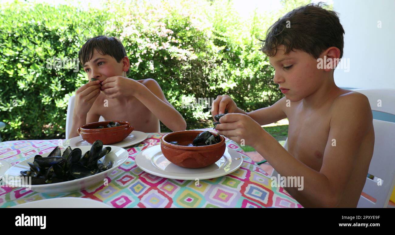 Children eating mussels lunch kids hi-res stock photography and images ...
