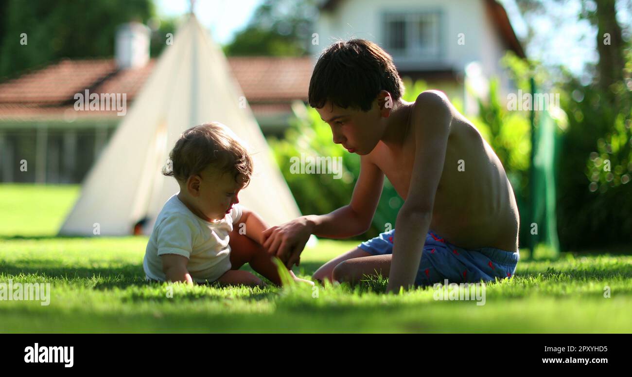 Children together in home backyard. Siblings interaction. Baby infant ...
