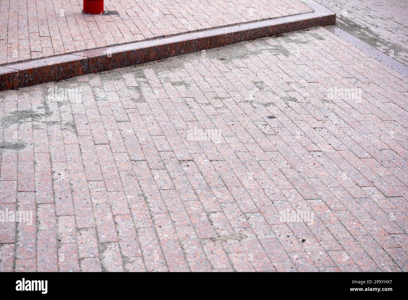 Red colored paving stones are laid on the road Stock Photo - Alamy