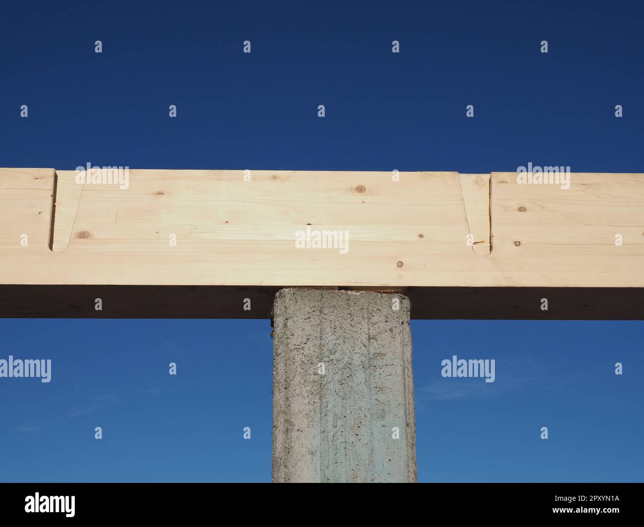 wooden beam on concrete pillar for roof construction works in a ...