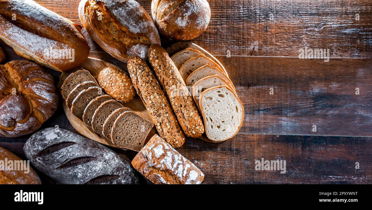 Assorted bakery products including loafs of bread and rolls Stock Photo ...