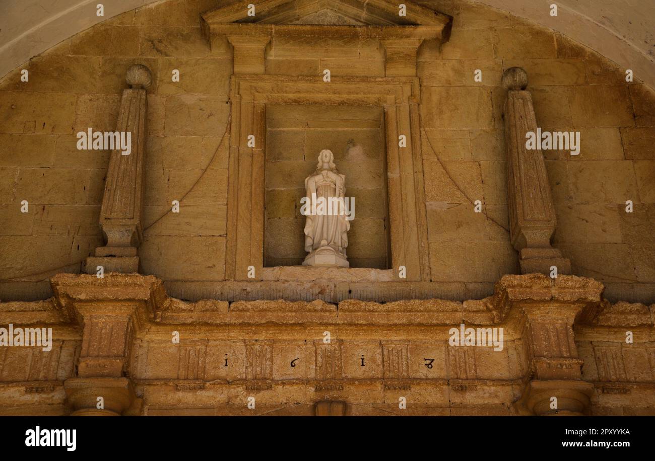 religious sculpture on a stone facade surrounded by columns and ...