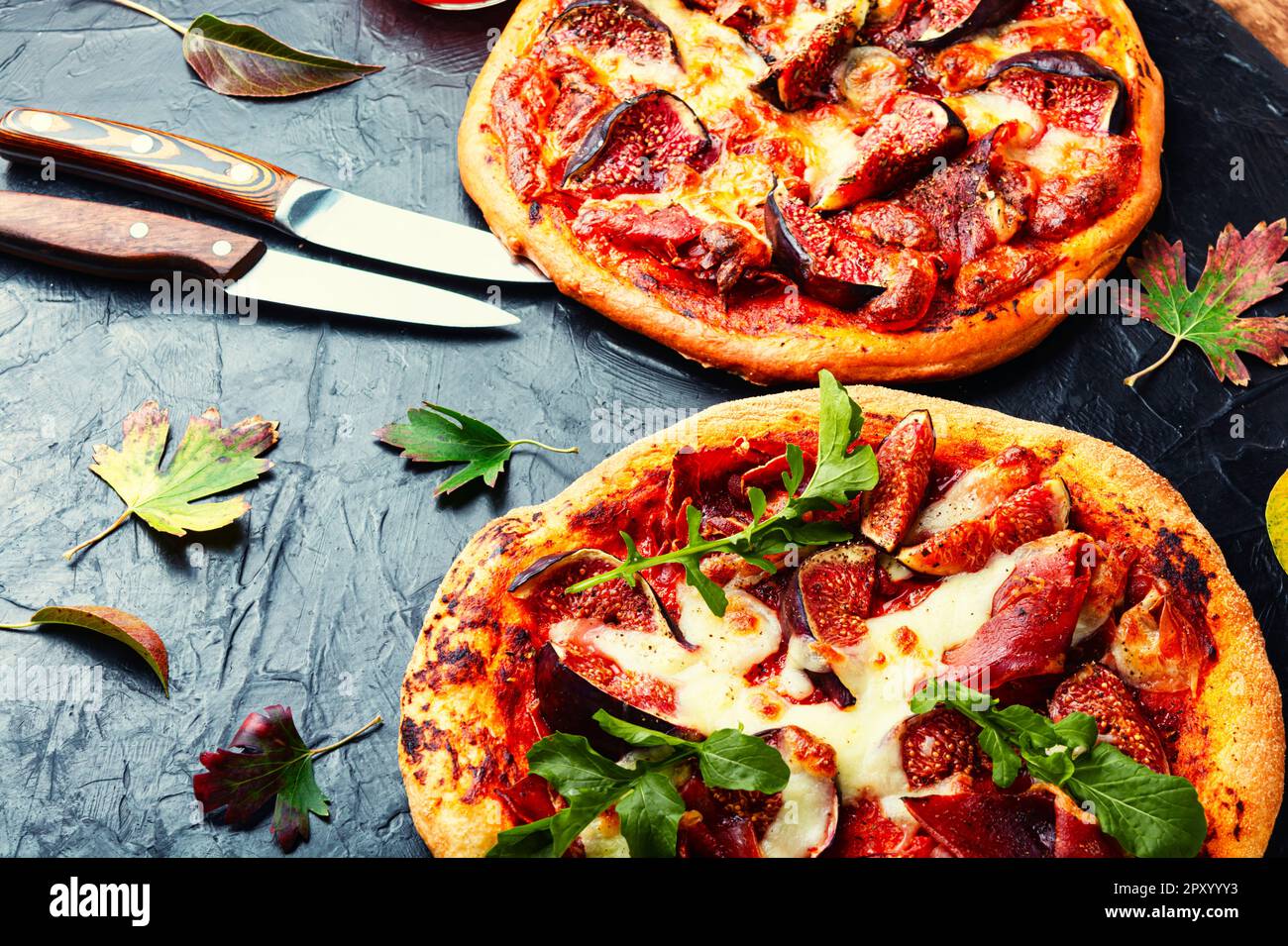 Homemade meat pizza with proscuitto and figs on stone background Stock ...