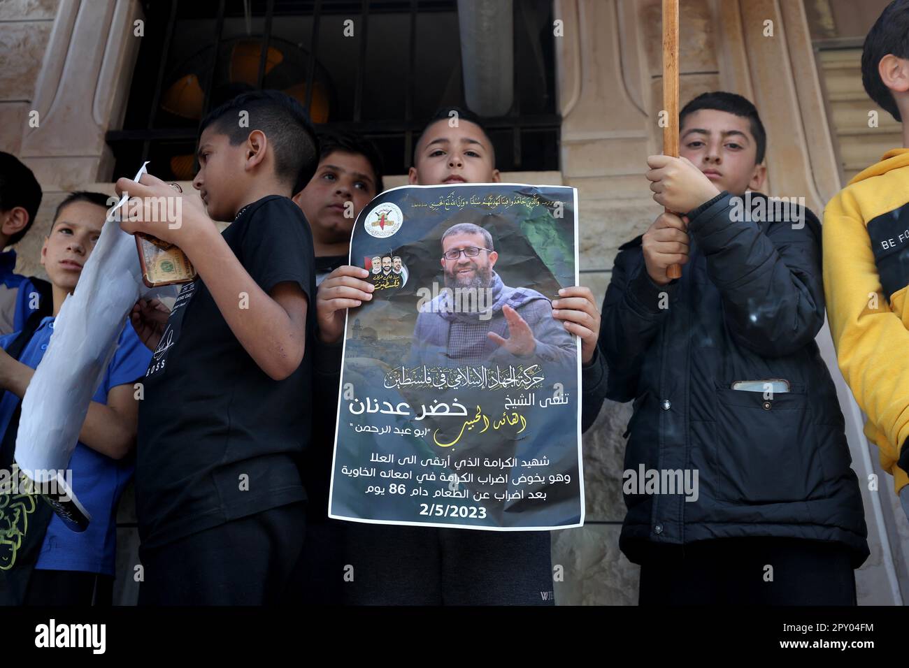 People give solace to the family of Khader Adnan (in the poster), as ...