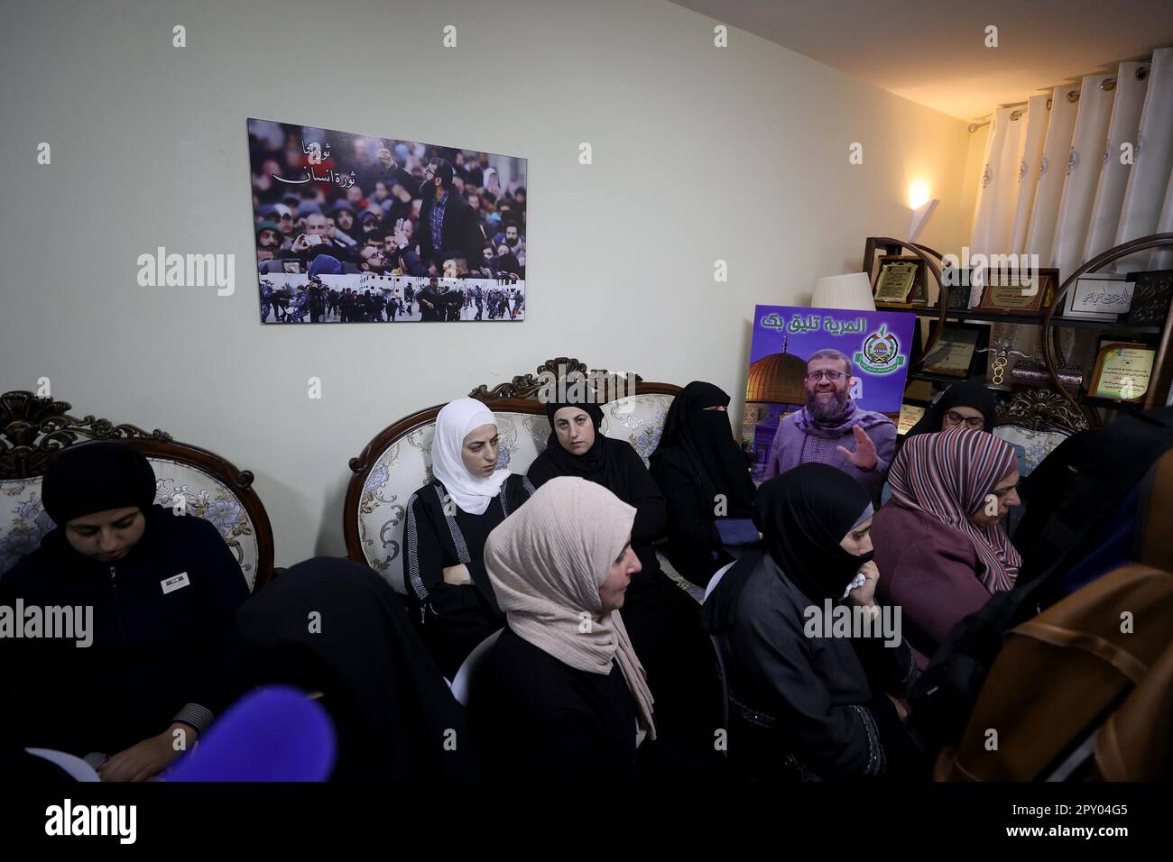 People give solace to Randa Musa (not seen), the wife of Khader Adnan ...