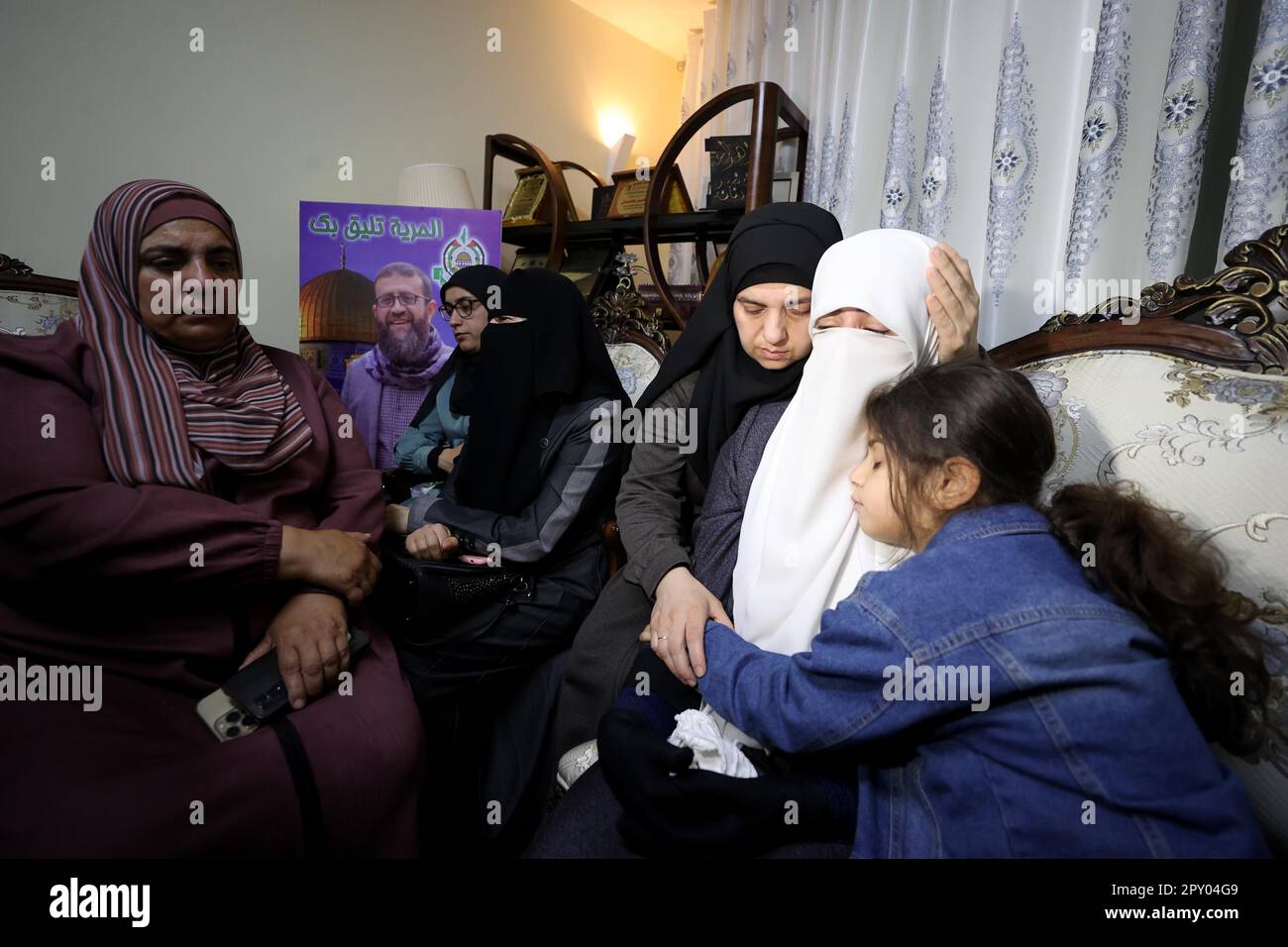 People give solace to Randa Musa (2nd R), the wife of Khader Adnan (in ...