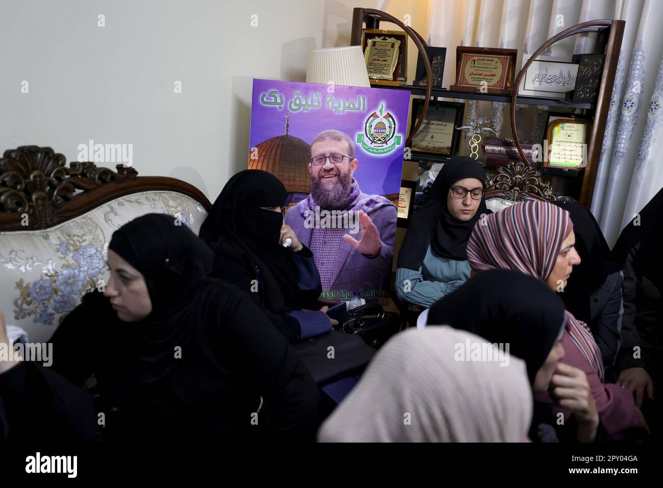 People give solace to Randa Musa (not seen), the wife of Khader Adnan ...