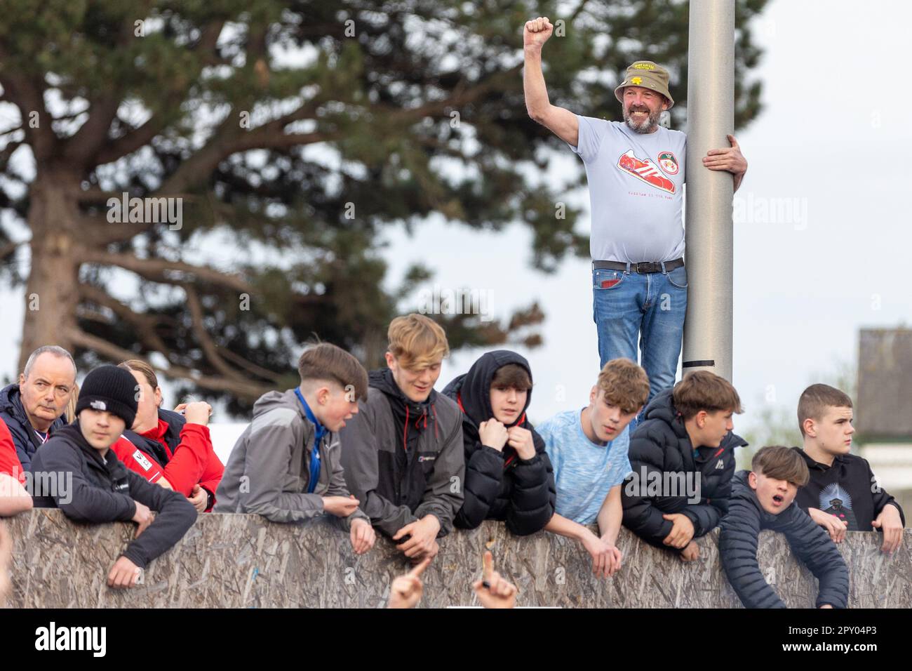 Wrexham, UK. 02nd May, 2023. A Wrexham AFC fan stands on lamppost ...