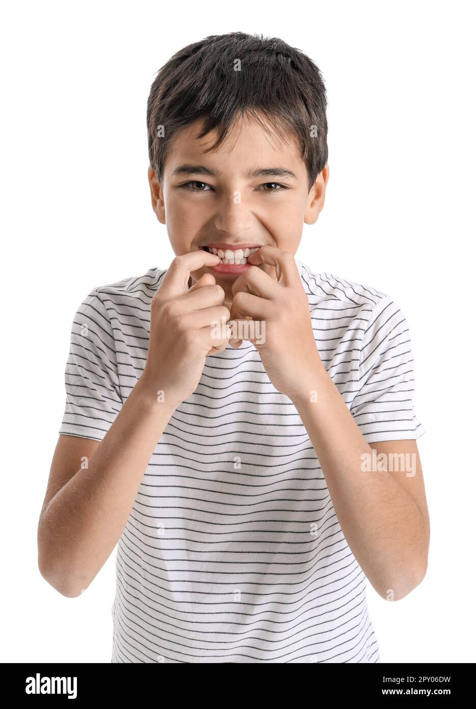 Angry little boy biting nails on white background Stock Photo - Alamy