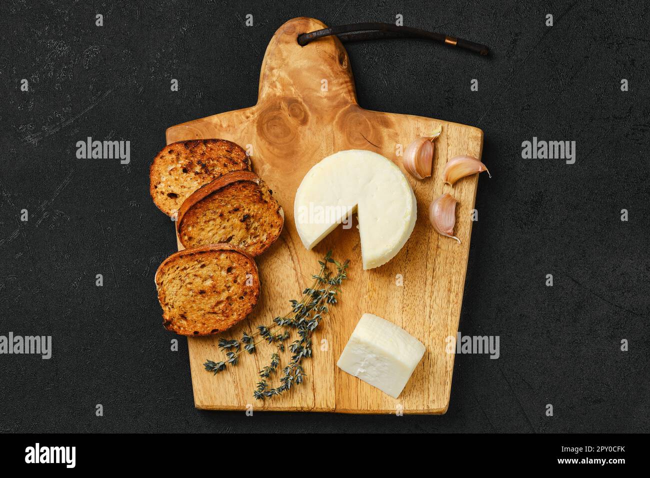 Top view of small goat cheese head and garlic toasted bread Stock Photo ...