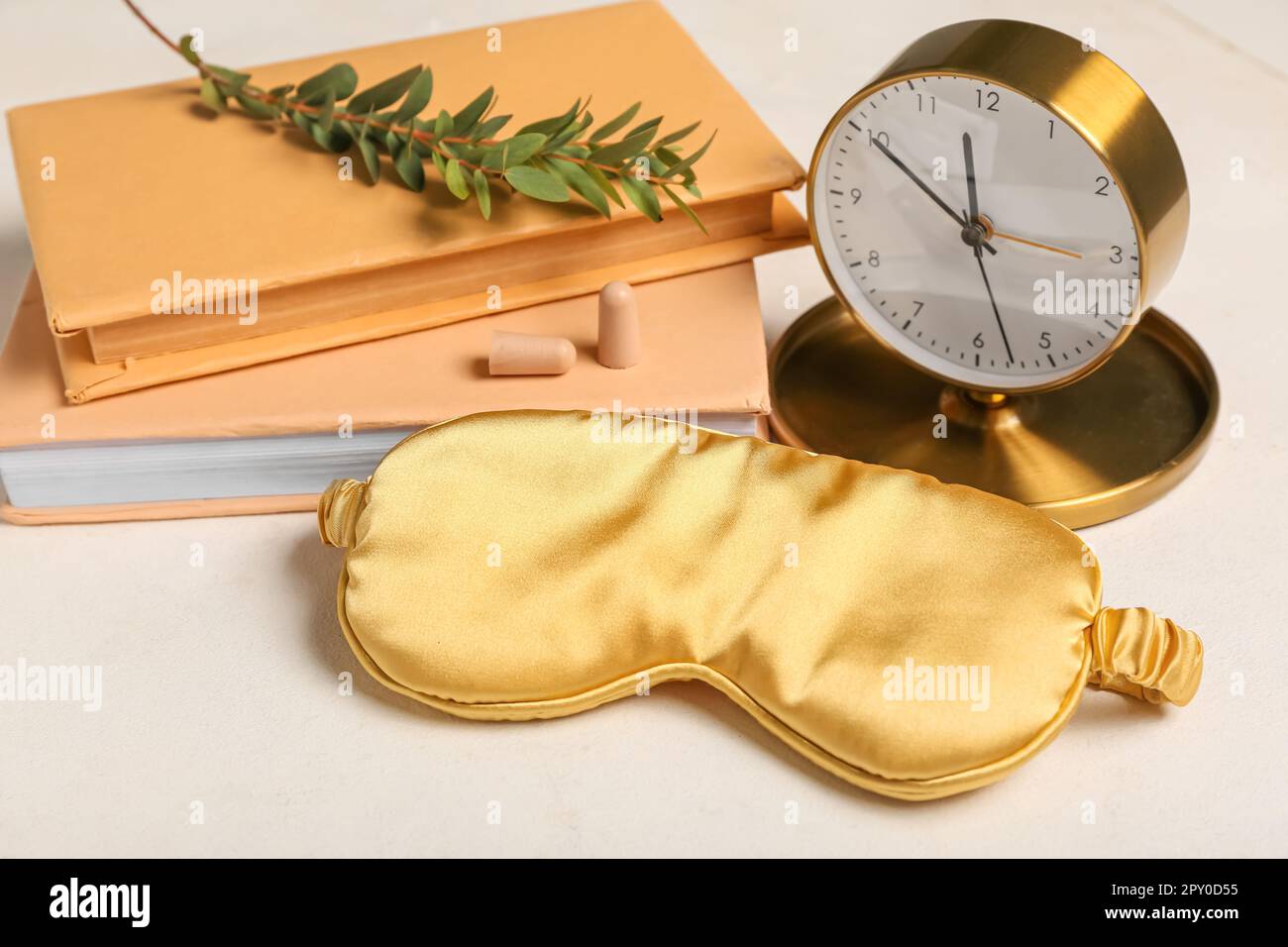 Sleep mask, earplugs and alarm clock on light background Stock Photo ...