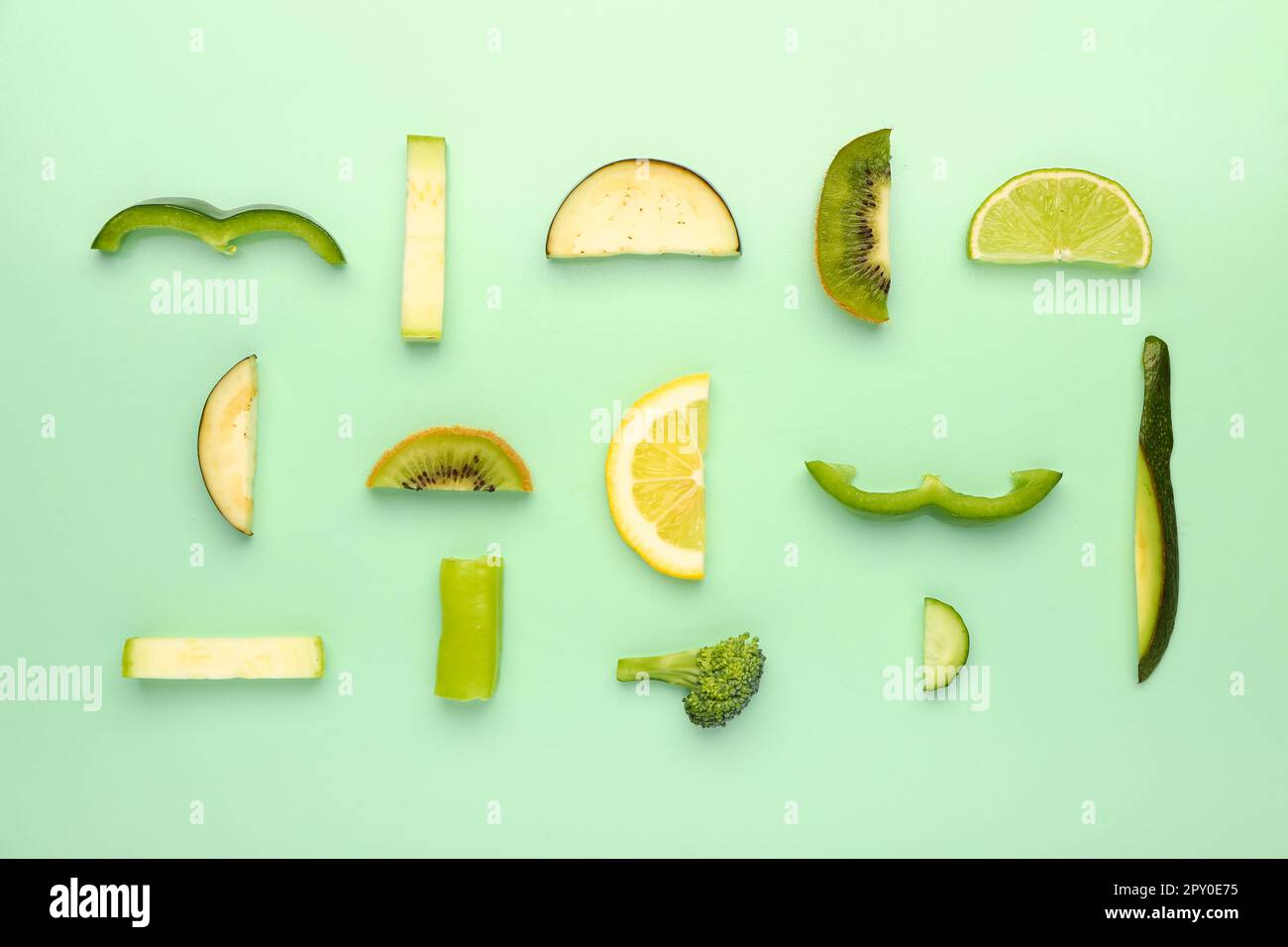 Composition with different fresh green vegetables and fruits on pale ...