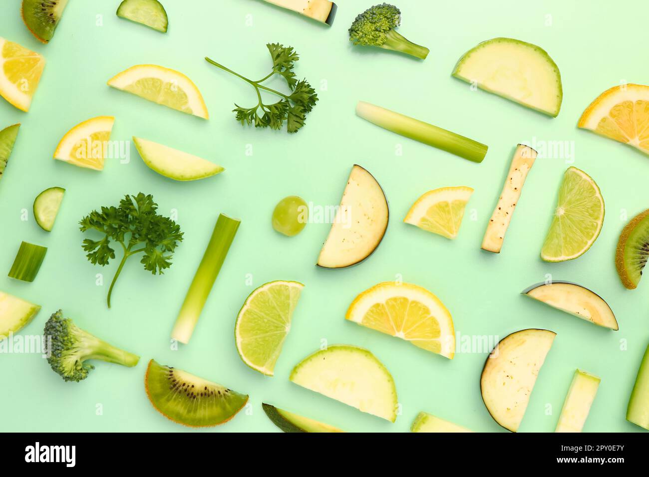 Composition with different fresh green vegetables and fruits on pale ...