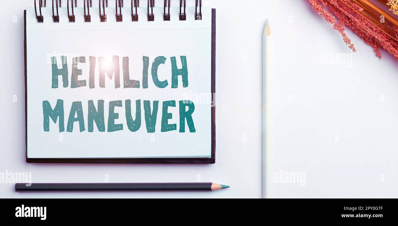 Hand writing sign Heimlich Maneuver, Word Written on application of ...