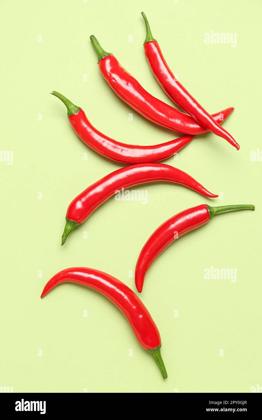 Fresh hot chili peppers on pale green background Stock Photo - Alamy