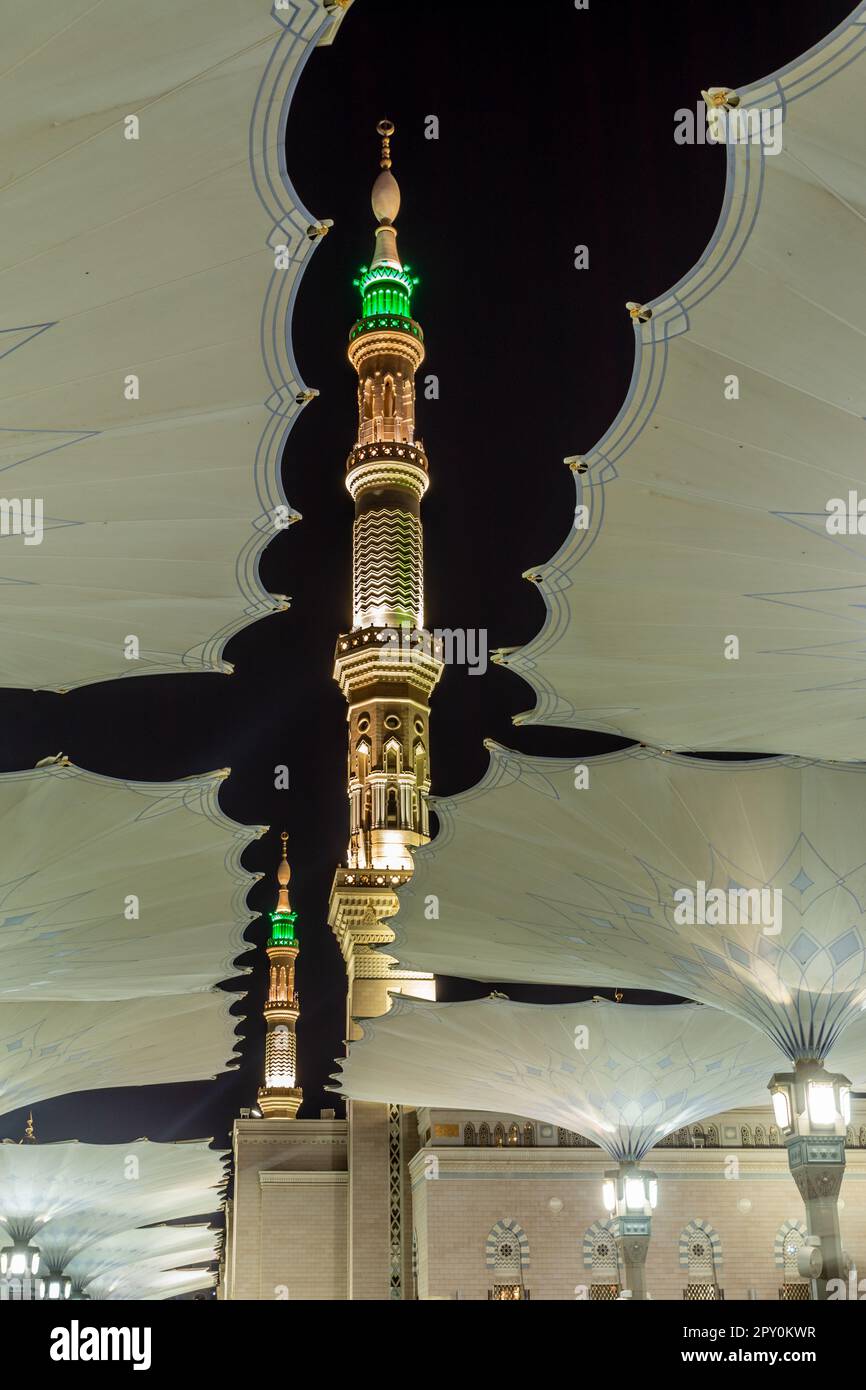 Prophet Mosque minarets with umbrellas in the foreground, Medina, Saudi ...